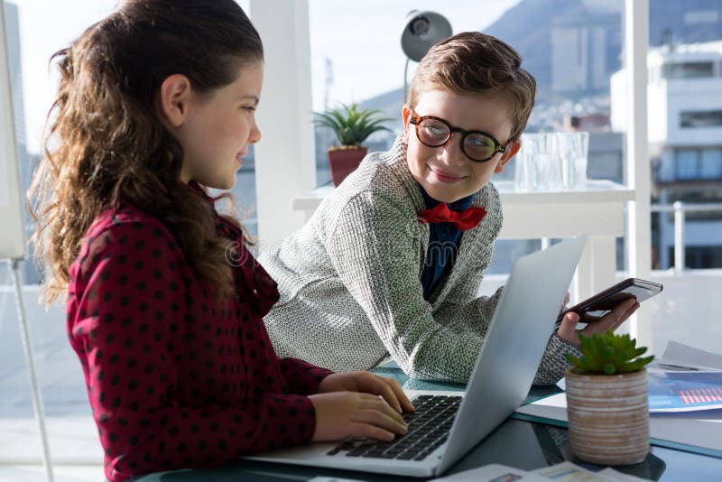 Smiling Business People Discussing Over Laptop in Office Stock Photo ...