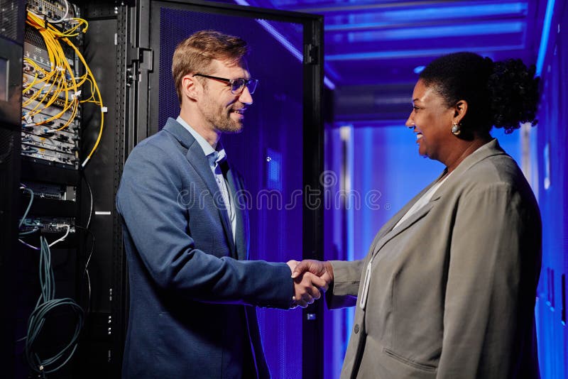 Smiling Business People Shaking Hands in Server Room Stock Photo ...