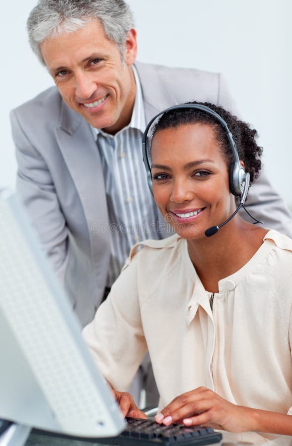 Smiling Business People Working at a Computer Stock Photo - Image of ...