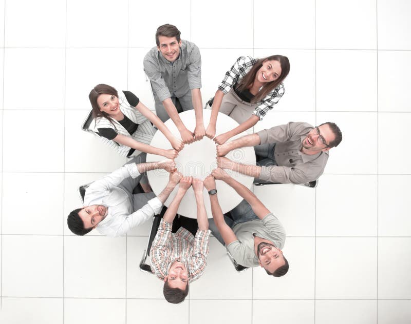 Smiling Business Team Folded Their Hands Forming a Circle Stock Photo ...