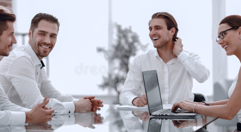 Smiling Business Team Sitting at the Desk. Stock Image - Image of ...