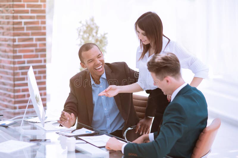 Smiling Business Team Talking ,sitting at Their Desk Stock Photo ...