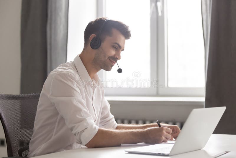 Smiling Businessman in Headset Using Laptop, Watching Webinar, Making ...