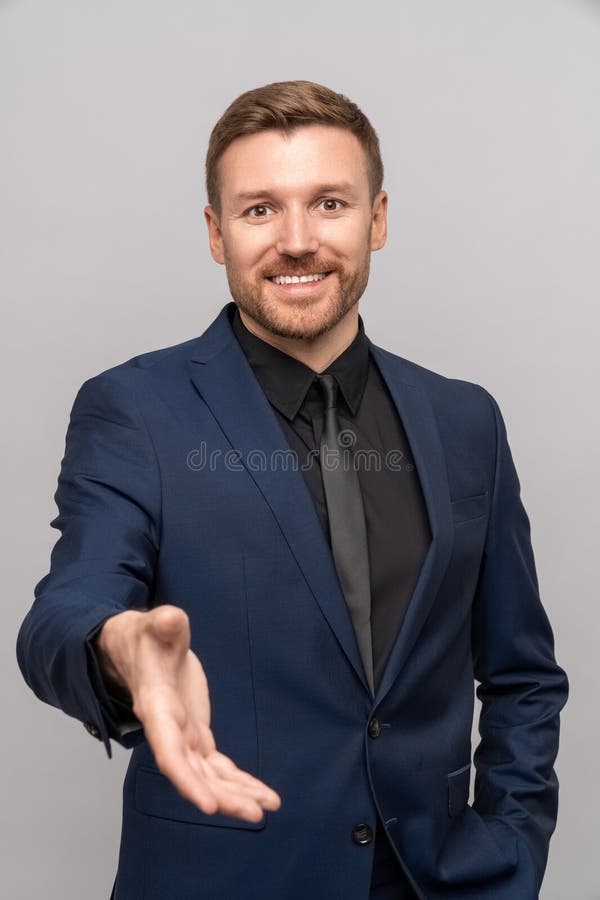 Smiling Businessman Holds Out Hand, Offering To Make Deal. Portrait Man ... Smiling Businessman Holds Out Hand, Offering To Make Deal. Portrait Man ...