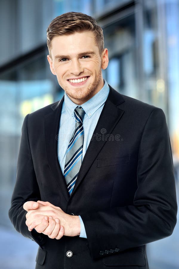 Smiling Businessman Posing Confidently Stock Photo - Image of company ...