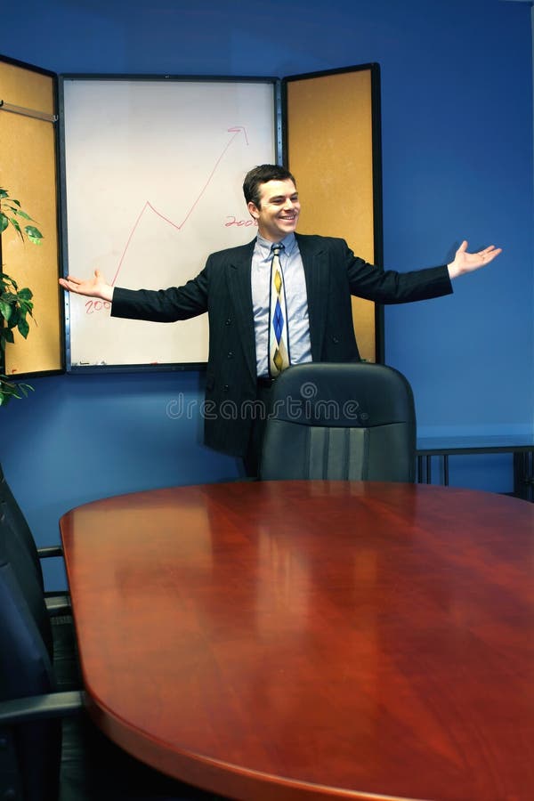 Smiling Businessman at a Presentation Stock Photo - Image of smiling ...