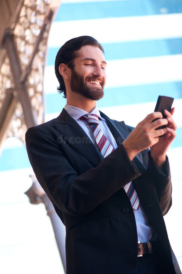Smiling Businessman Sending Text Message on Mobile Phone Stock Photo ...