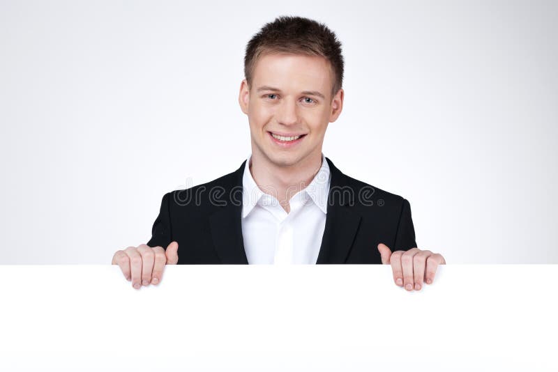 Smiling Businessman Standing Behind the Blank Poster. Stock Image ...