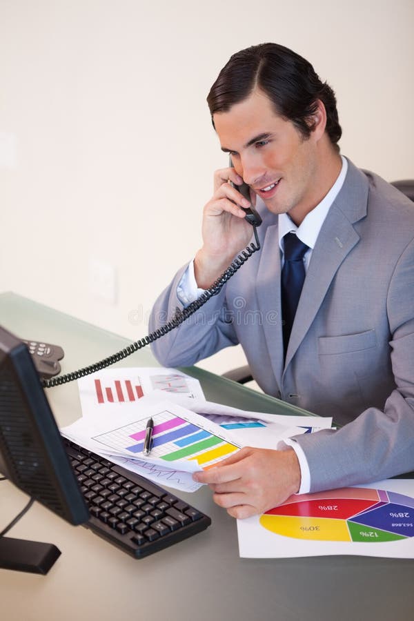 Smiling Businessman Talking about Statistics on the Phone Stock Image ...