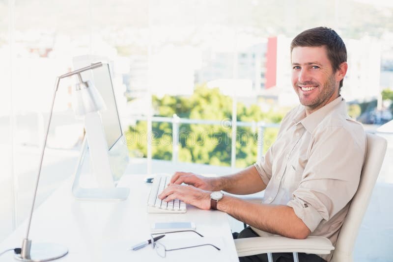 Smiling Businessman Using His Computer at His Desk Stock Image - Image ...