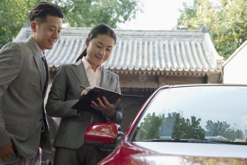 Smiling Businesspeople Working Outdoors by Red Car Stock Photo - Image ...