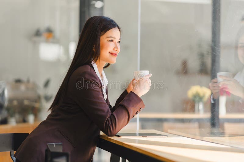 Smiling Businesswoman Enjoying Coffee Break by Window. Stock Photo ...