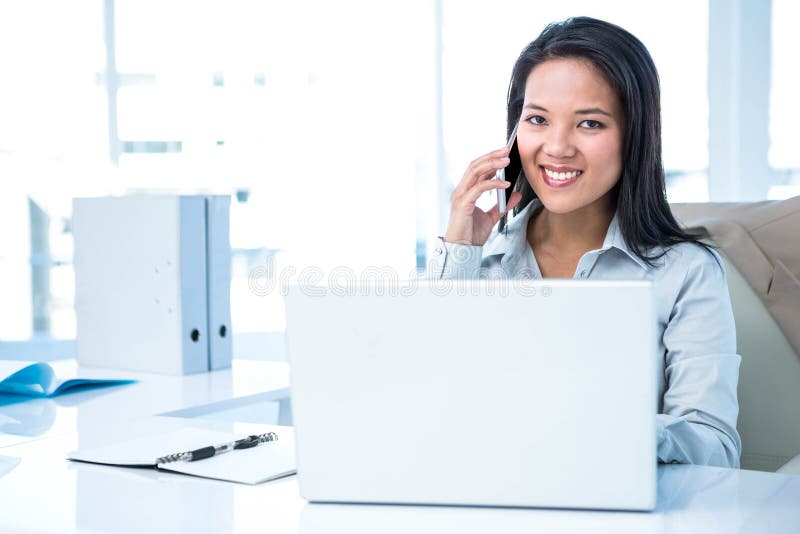 Smiling Businesswoman Phoning at the Desk Stock Image - Image of ...