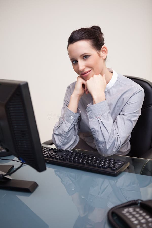 Smiling Businesswoman Waiting Patiently at Her Computer Stock Image ...