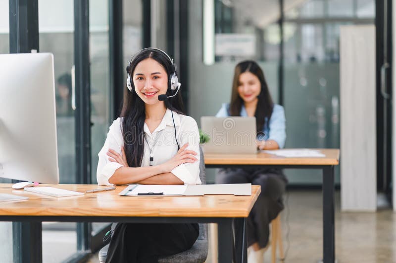 Smiling Call Center Agents Wearing Headsets, Working at Desks with ...