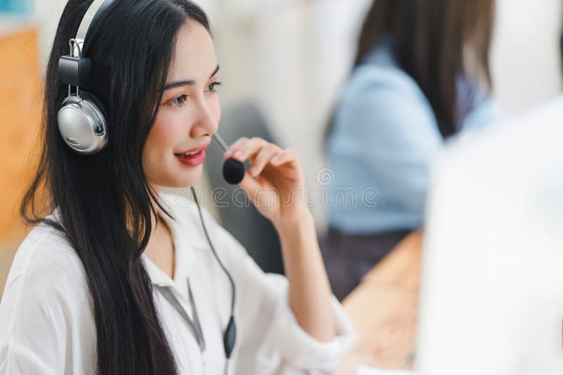 Smiling Call Center Agents Wearing Headsets, Working at Desks with ...