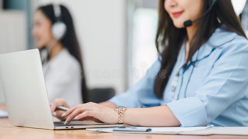 Smiling Call Center Agents Wearing Headsets, Working at Desks with ...