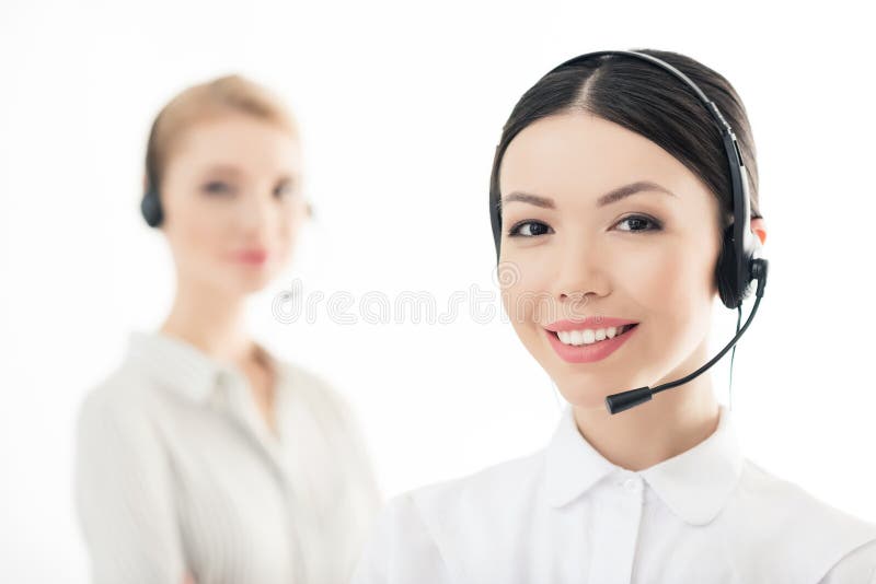 Smiling Call Center Operator in Headset with Colleague Behind Stock ...