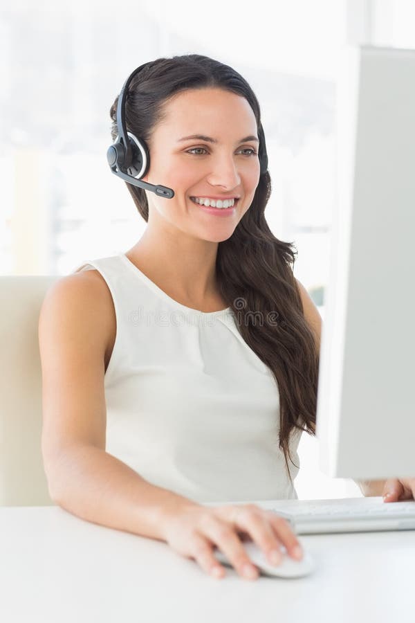 Smiling Call Centre Agent Sitting at Her Desk on a Call Stock Image ...