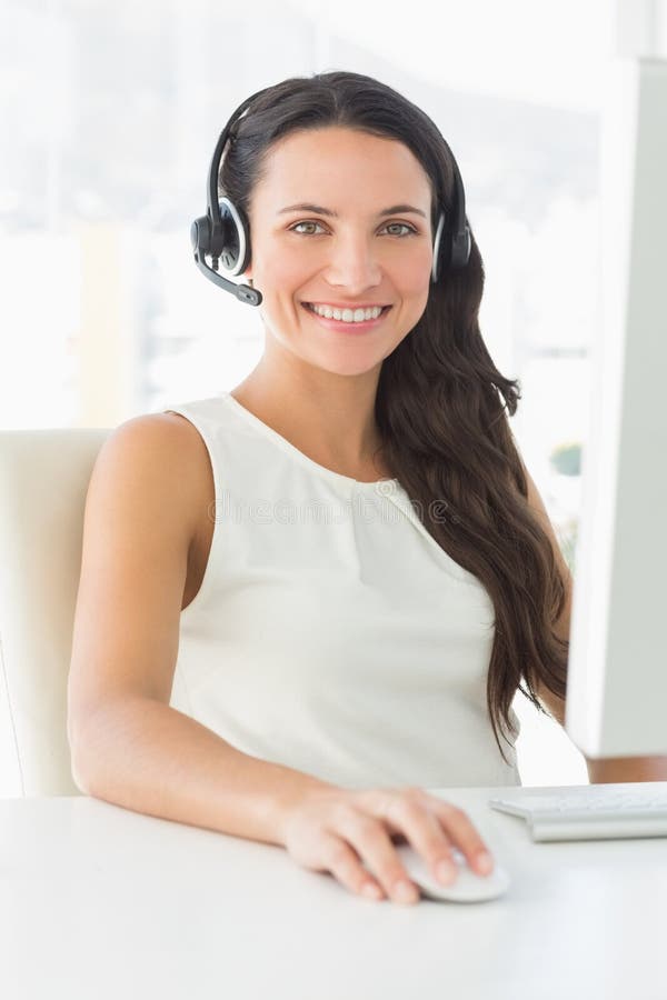 Smiling Call Centre Agent Sitting at Her Desk Stock Photo - Image of ...