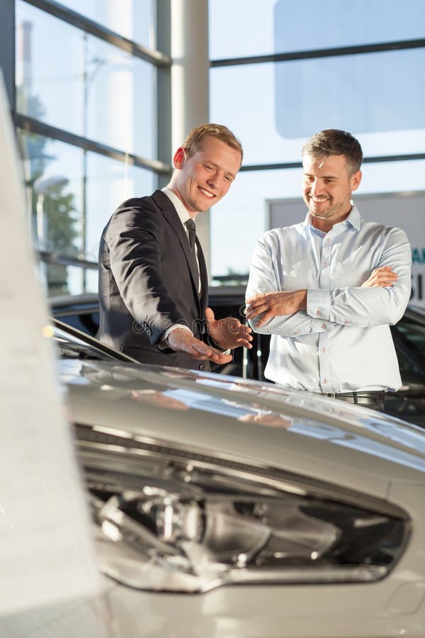 Smiling Car Salesman with Customer Stock Photo - Image of drive ...