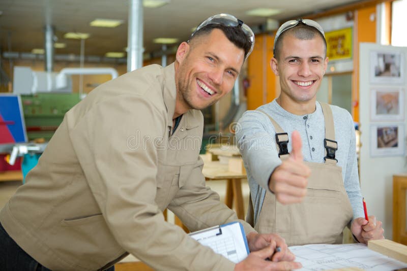 Smiling Carpenter and Apprentice Holding Thumbs Up Stock Photo - Image ...