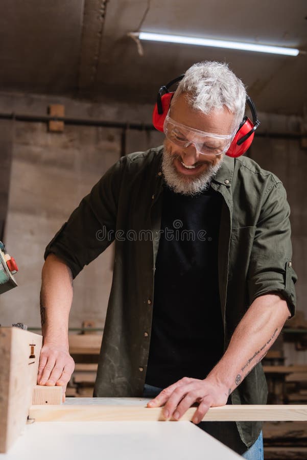 Smiling Carpenter in Goggles Working on Stock Photo - Image of ...