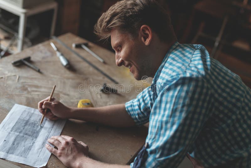 Smiling carpenter at work stock photo. Image of young - 121496800