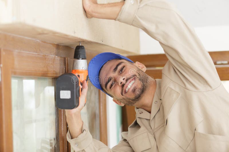 Smiling carpenter at work stock photo. Image of household - 267209056