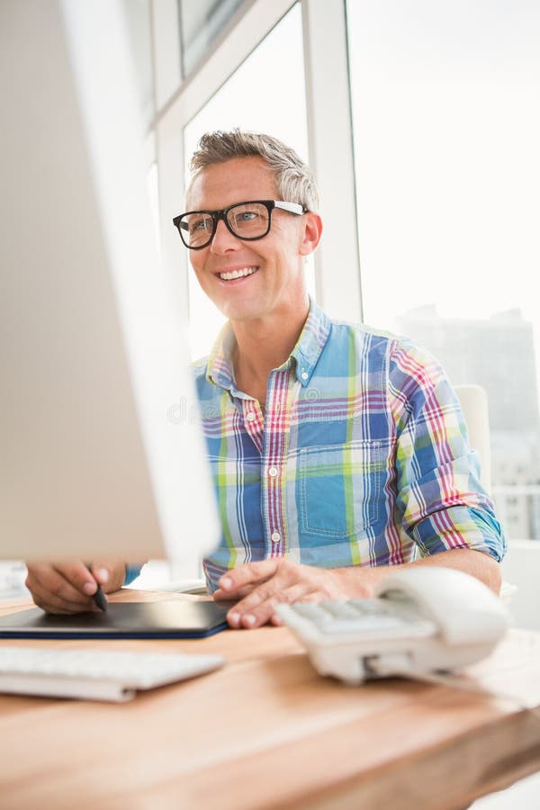 Smiling Casual Designer Using Computer and Digitizer Stock Photo ...