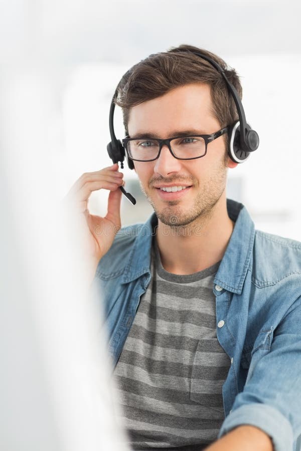 Smiling Casual Young Man with Headset Using Computer Stock Image ...