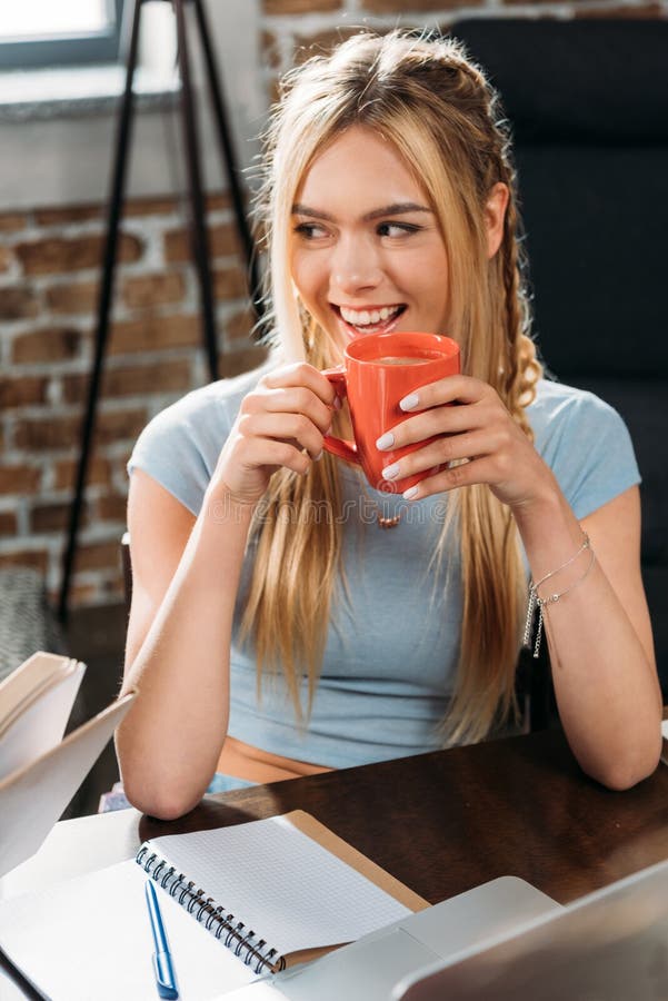 Smiling Caucasian Woman Drinking Coffee while Sitting at Table Stock ...