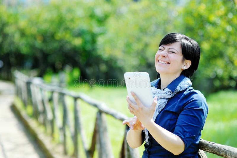 Smiling Caucasian Woman Using Tablet Computer Stock Image - Image of ...