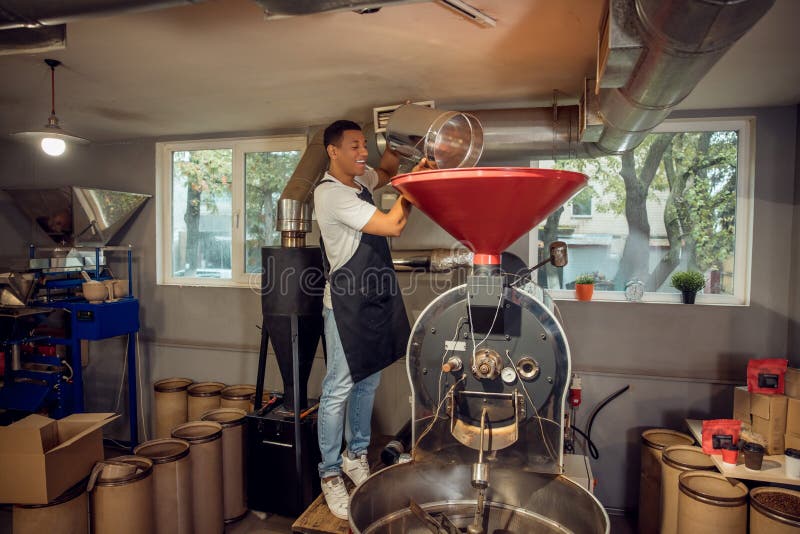 Joyous Roast Master Adding Coffee Grains into the Roasting Machine ...