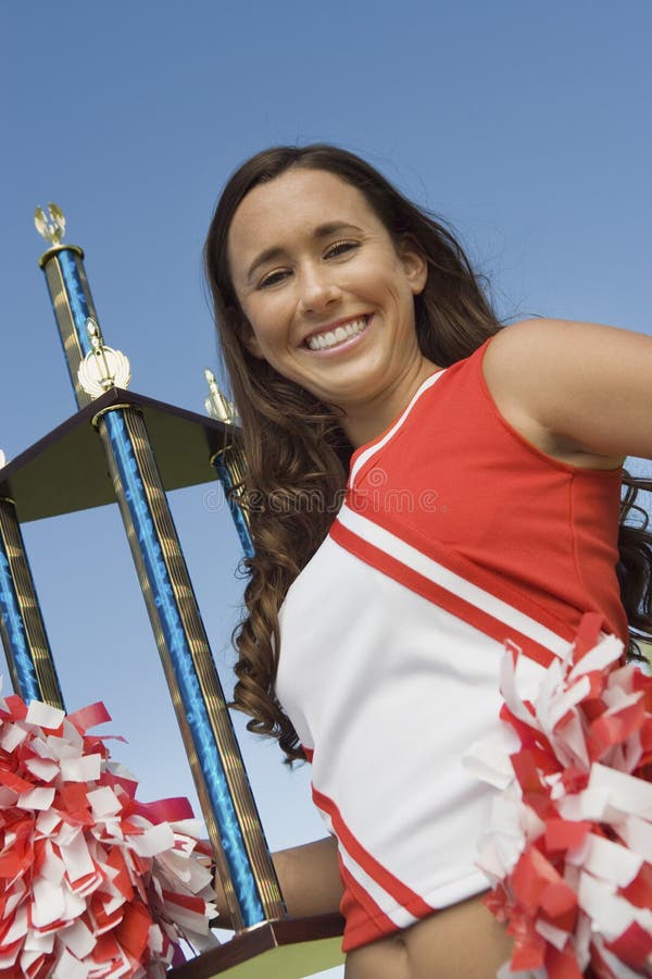 Smiling Cheerleader Sitting on Bench Stock Photo - Image of outdoors ...