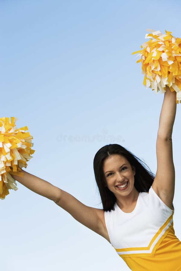 Smiling Cheerleader Sitting on Bench Stock Photo - Image of outdoors ...