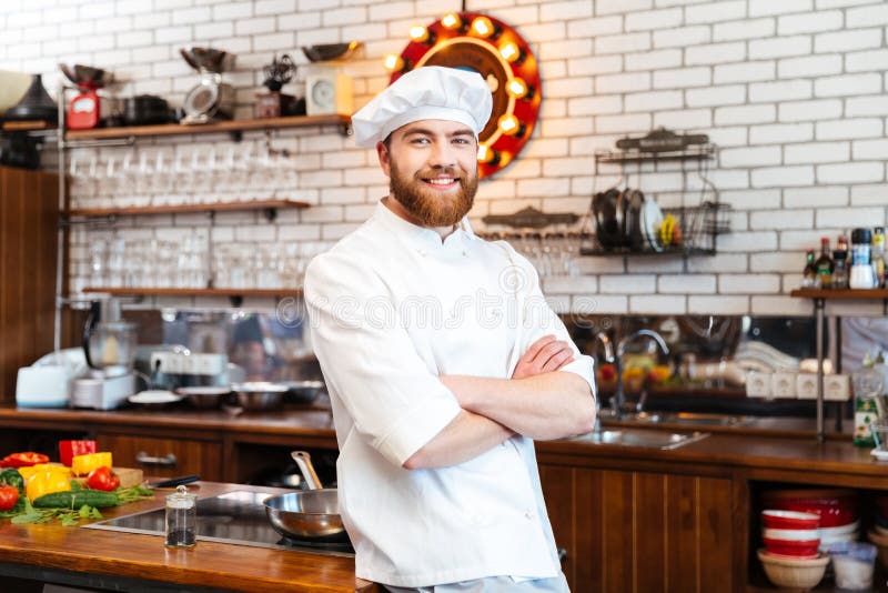 Smiling Chef Cook Standing with Hands Folded on the Kitchen Stock Photo ...