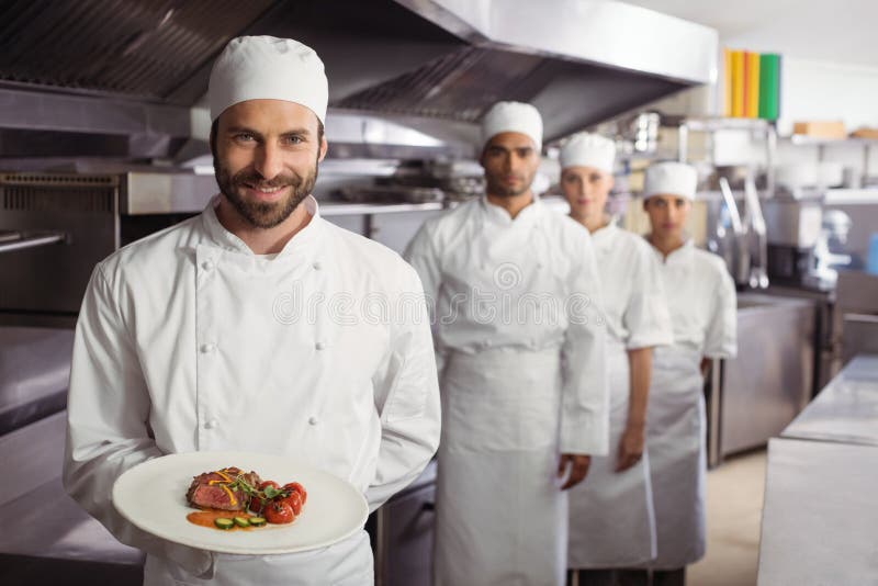 Smiling Chef Holding Delicious Dish in Kitchen Stock Image - Image of ...