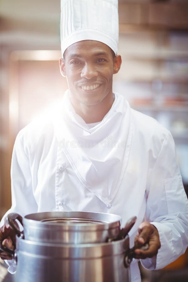 Smiling Chef in Kitchen Holding Cooking Pot Stock Photo - Image of ...