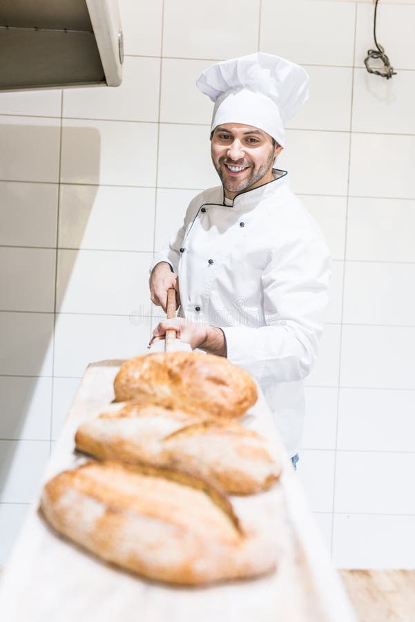 Smiling Chef Taking Out Loaves of Bread Stock Photo - Image of chef ...