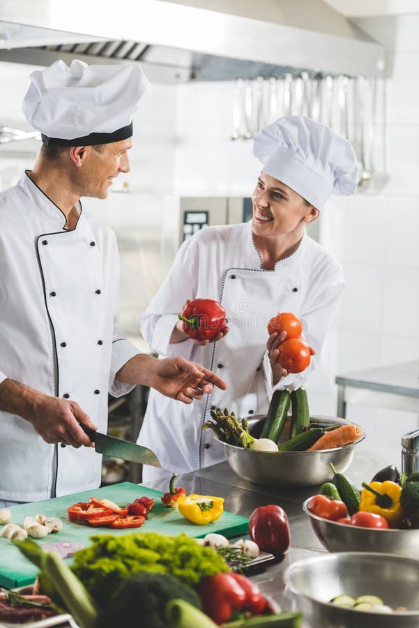 Smiling Chefs Cooking and Looking at Each Other Stock Image - Image of ...