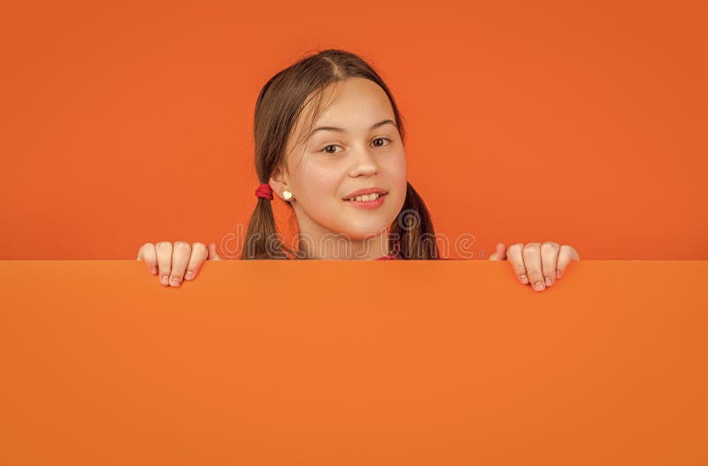 Smiling Child Behind Blank Orange Paper with Copy Space for ...