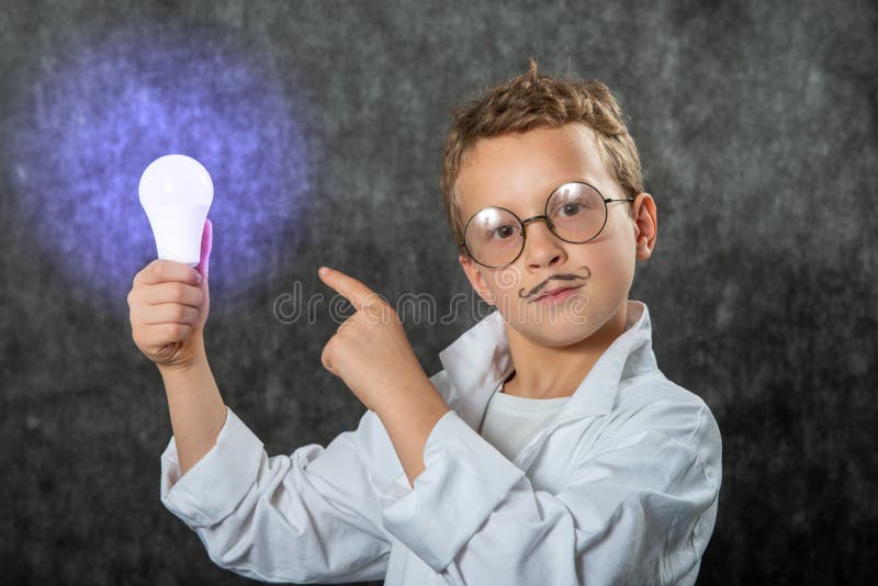 Smiling Child Boy with a Light Bulb Stock Photo - Image of ...