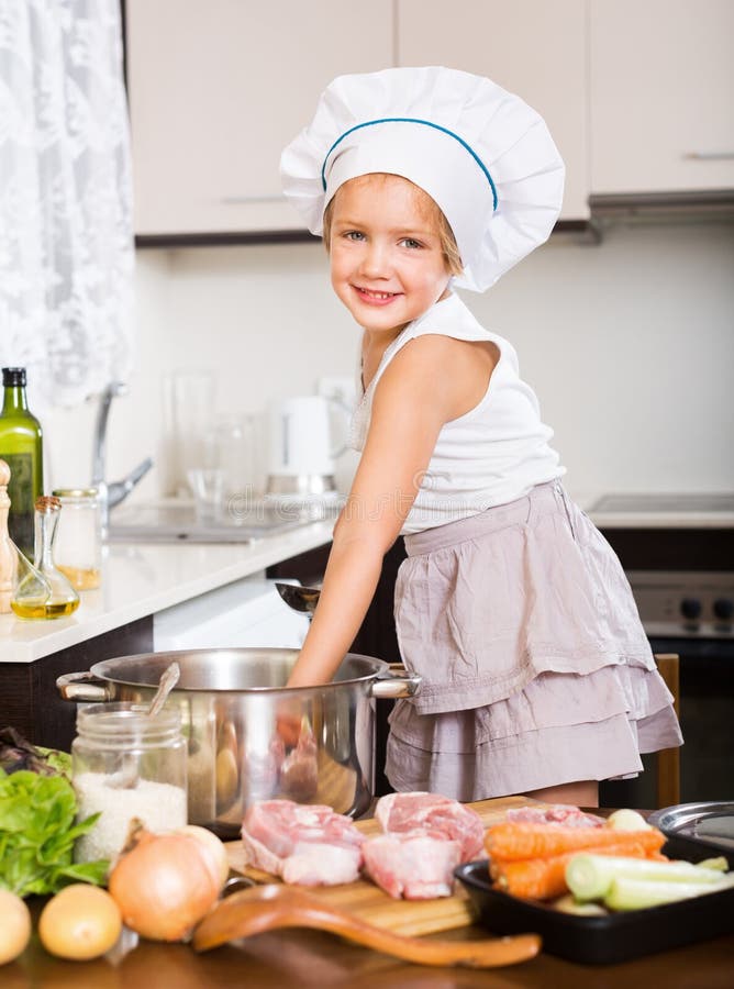 Smiling child cooking soup stock photo. Image of making - 49974660