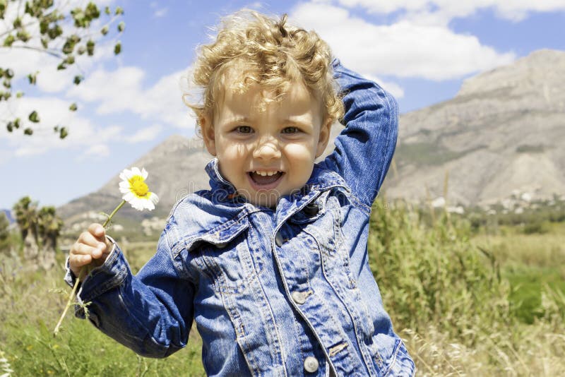 Smiling Child with Flower in the Field Stock Photo - Image of outside ...