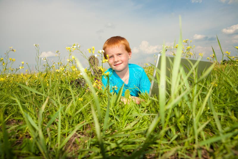Smiling Child with Laptop Computer on Meadow Stock Image - Image of ...