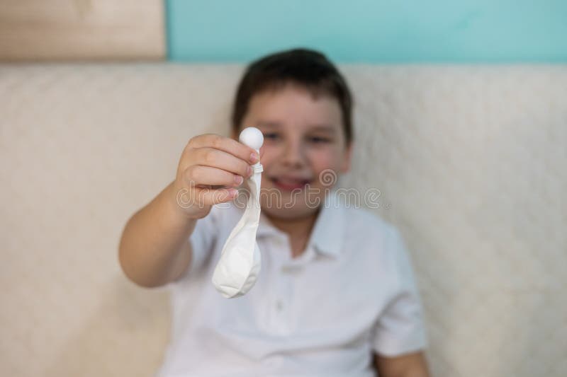 A Smiling Child Practices Autoinsufflation Using a Nasal Balloon To ...
