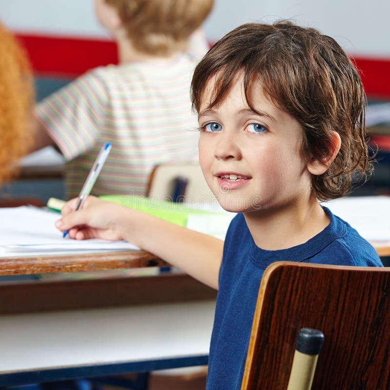 Smiling Child Sitting at Table Stock Image - Image of classroom, class ...