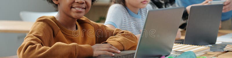 Smiling Child Using Laptop for Learning in Classroom Stock Photo ...