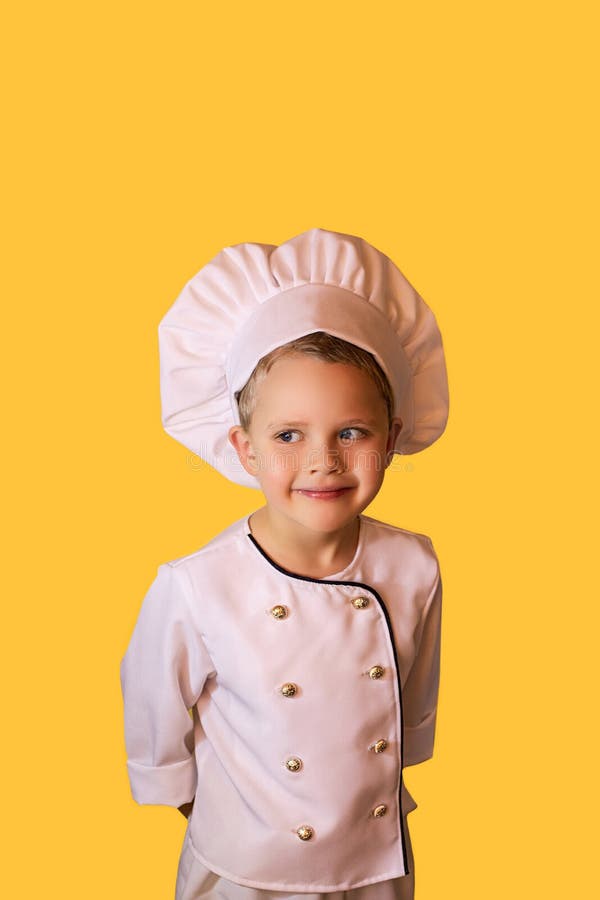 Smiling Child in White Chef Uniform with a Funny Hat. Cheerful Yellow ...